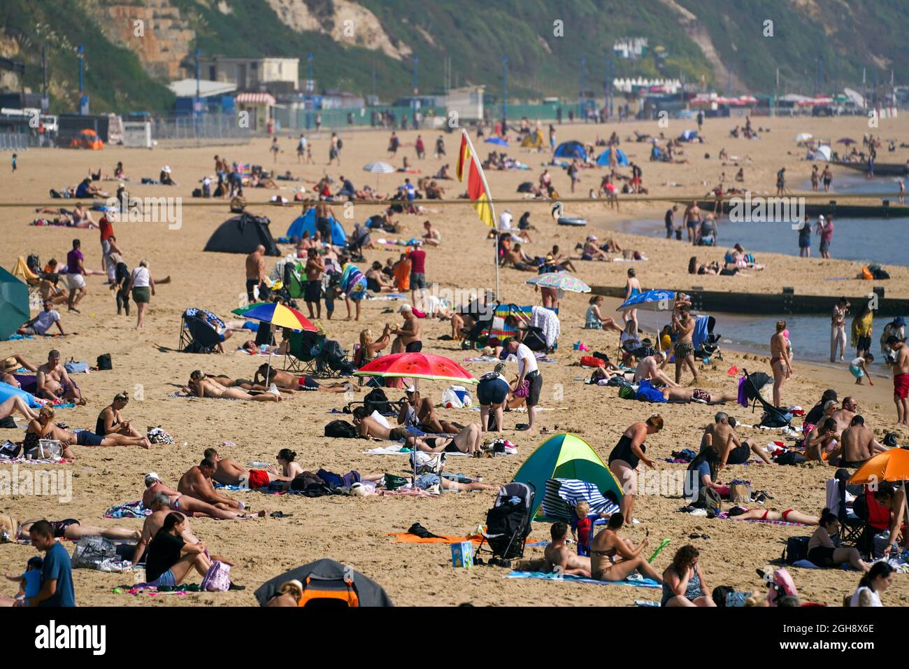 People enjoy the warm weather on Bournemouth Beach in Dorset. Picture ...