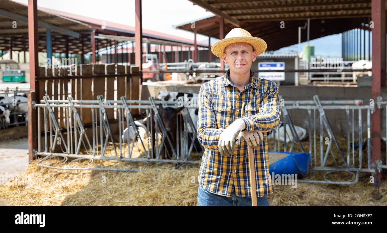 Portrait of confident young adult man engaged in livestock breeding ... Portrait of confident young adult man engaged in livestock breeding ...
