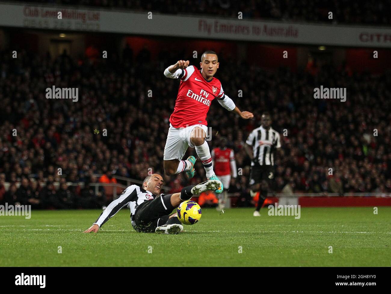 Arsenal's Theo Walcott goes past Newcastle's James Perch during ...