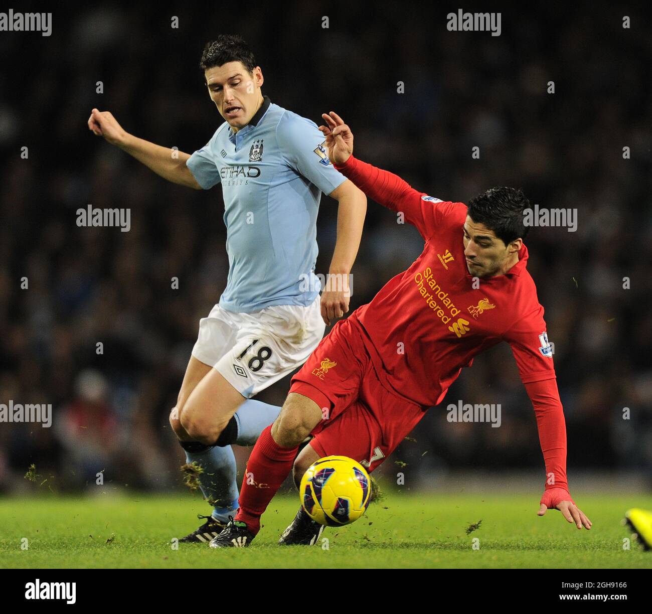 Gareth Barry of Manchester City tackles Luis Suarez of Liverpool during ...