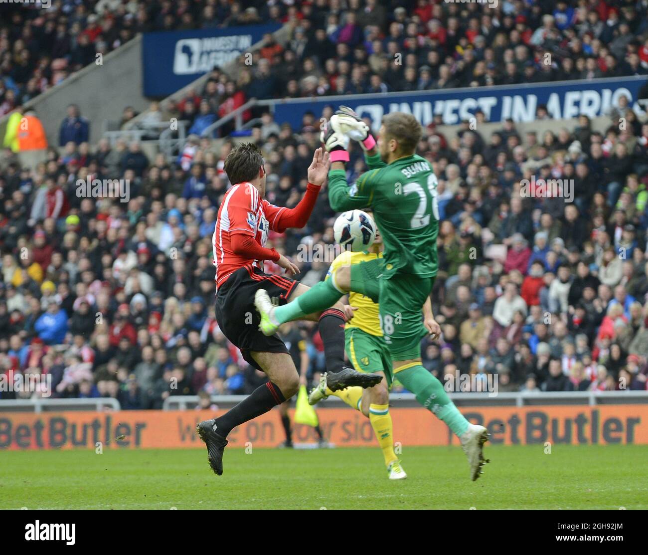 Mark Bunn of Norwich City (R) clears the ball outside the penalty area ...