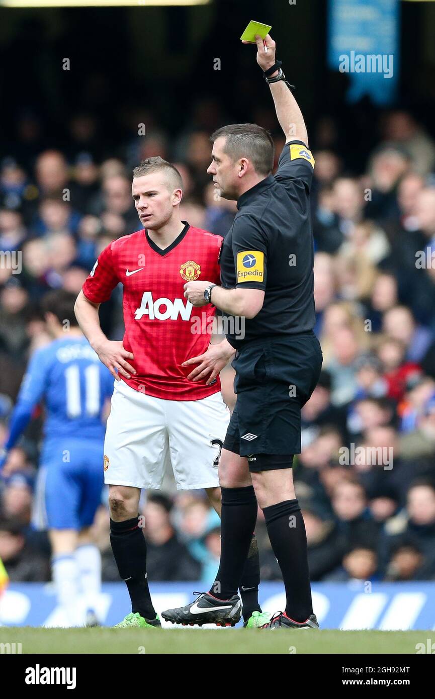 Manchester United's Tom Cleverley is shown a yellow card by referee Phil Dowd during the FA Cup ...