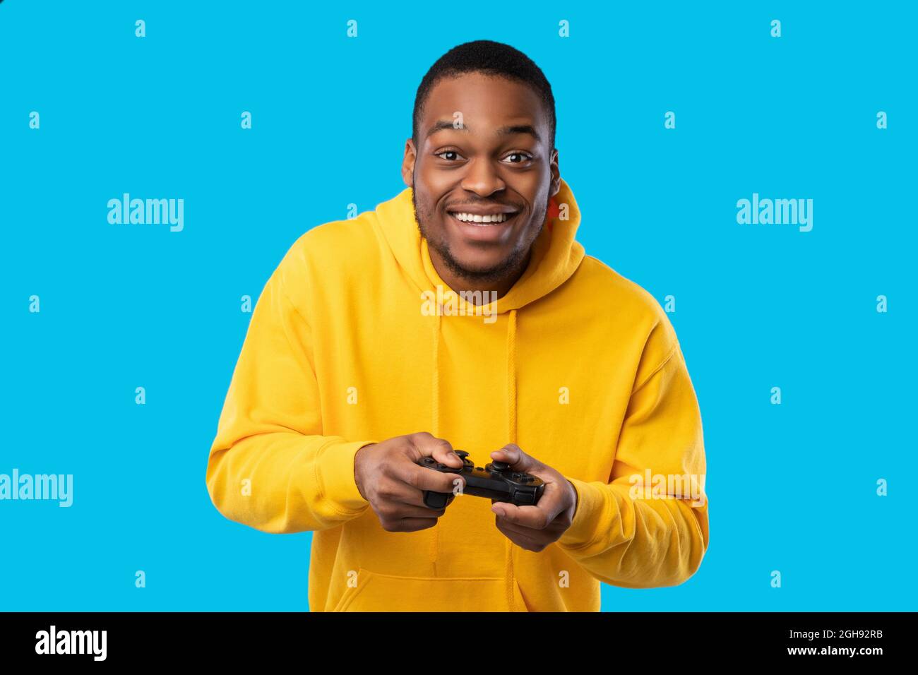 Cheerful Black Guy Playing Videogame Holding Game Controller, Blue ...