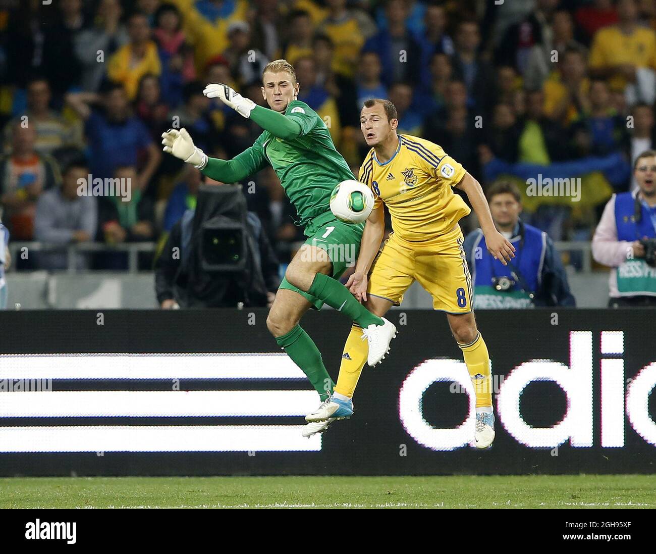 Ukraine's Roman Zozulya tussles with England's Joe Hart during the FIFA ...