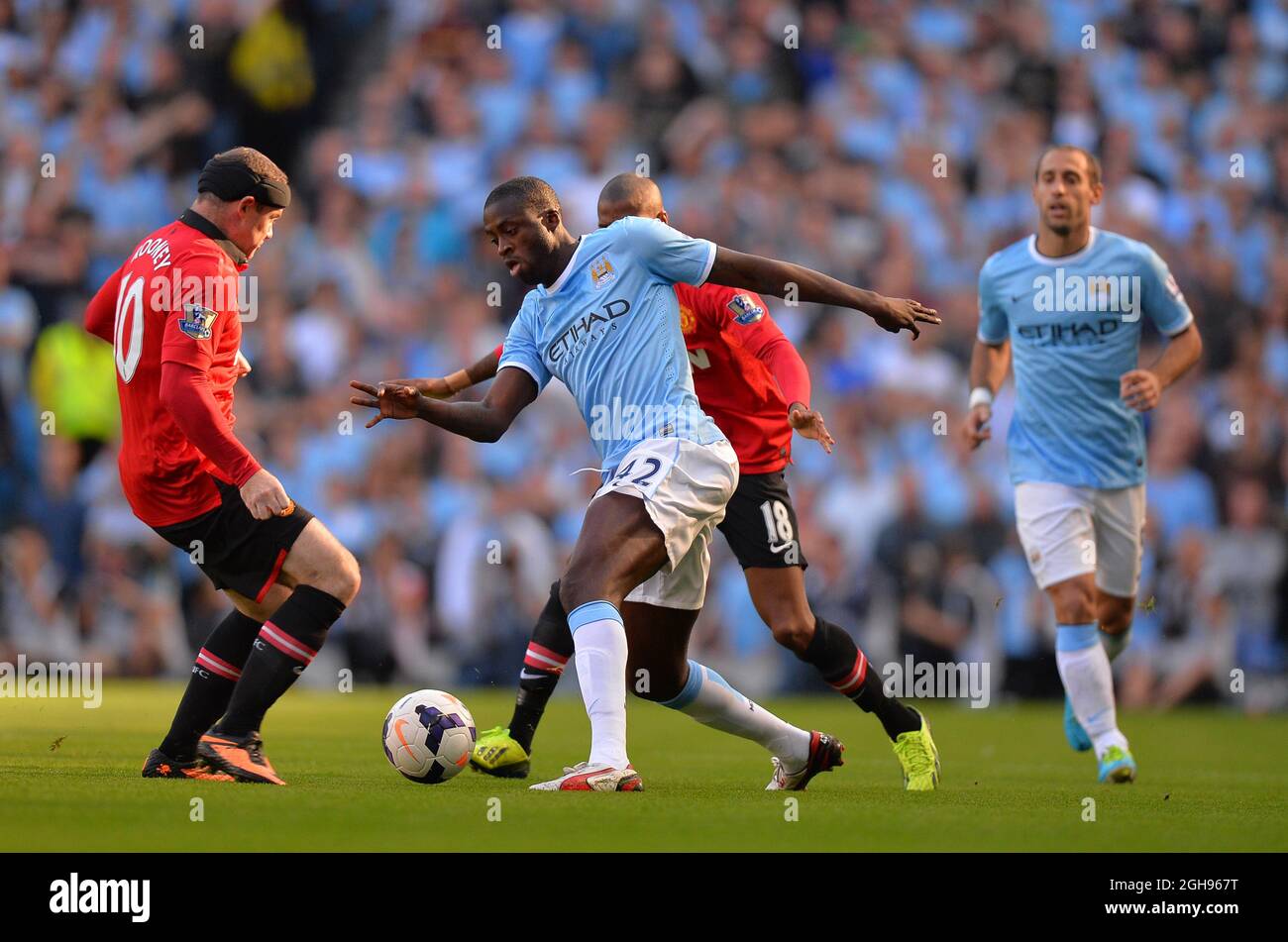 Yaya Toure of Manchester City tussles with Wayne Rooney of Manchester ...