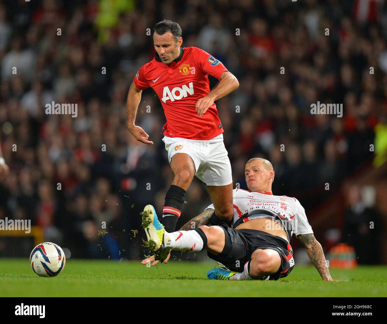 Martin Skrtel of Liverpool tackles with Ryan Giggs of Manchester United ...