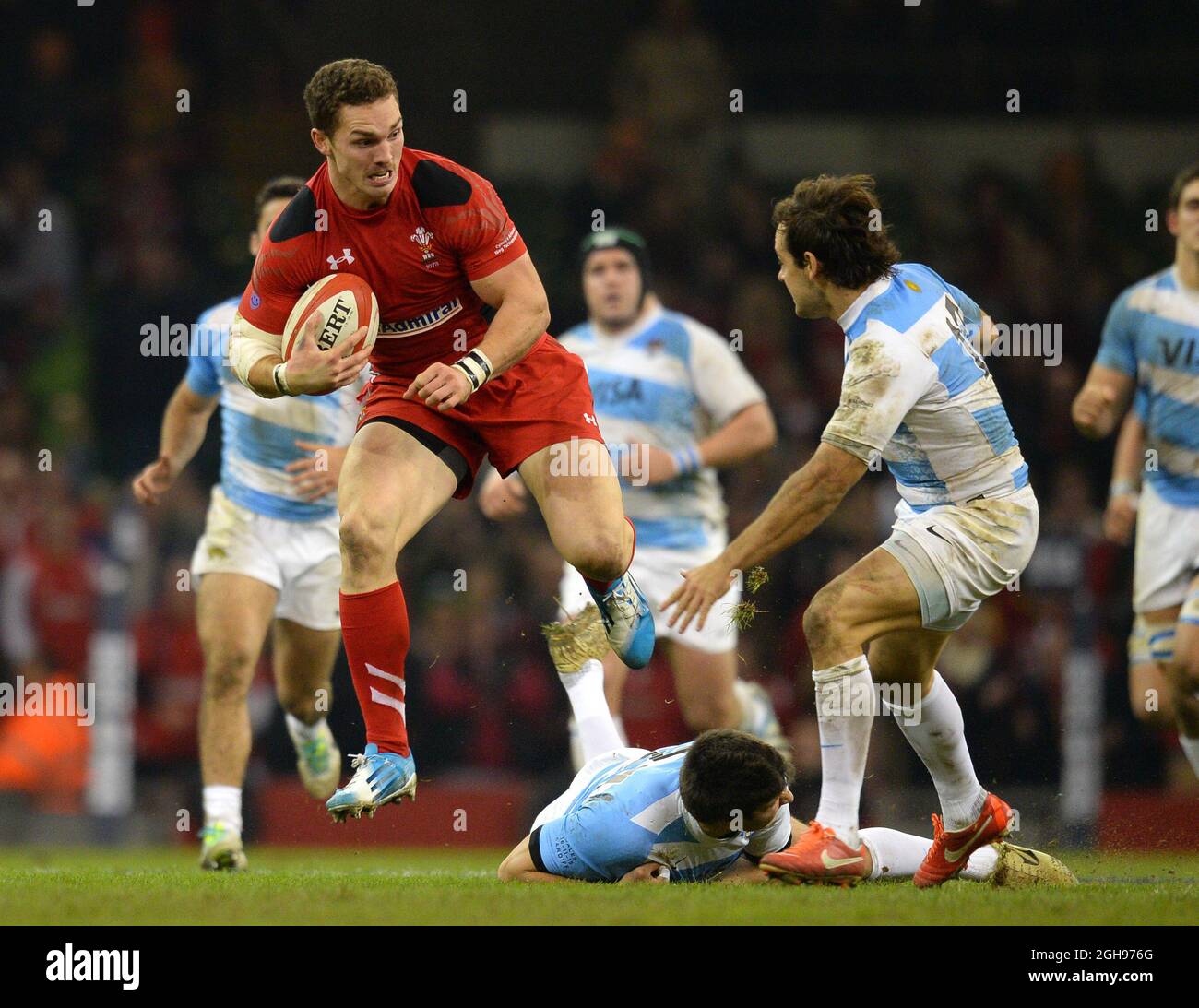 George North of Wales breaks a tackle by Lucas Gonzalez playing for ...