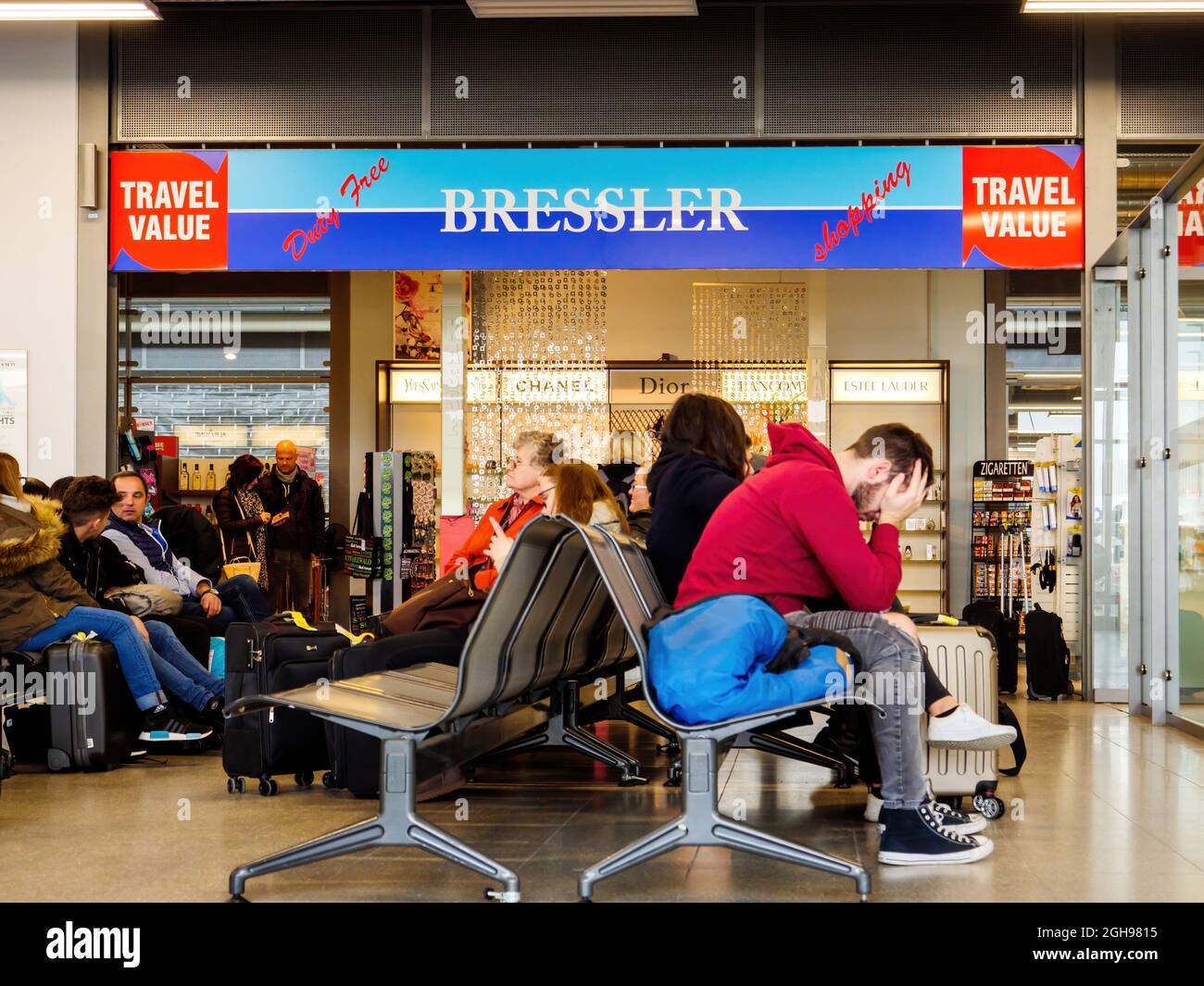 Tired people passengers waiting in the terminal in small Baden Airport ...
