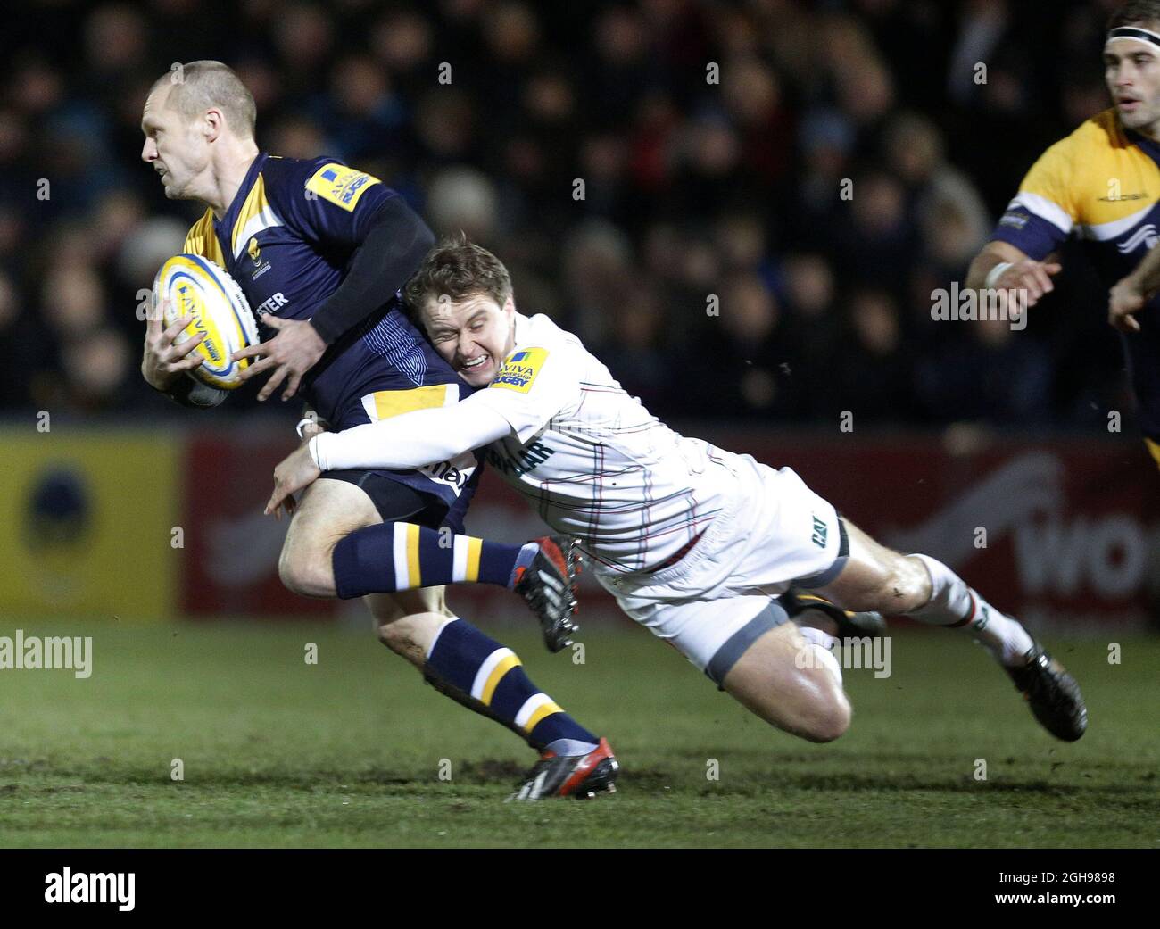 Matthew Tait of Leicester Tigers tackles Paul Warwick (left) of ...