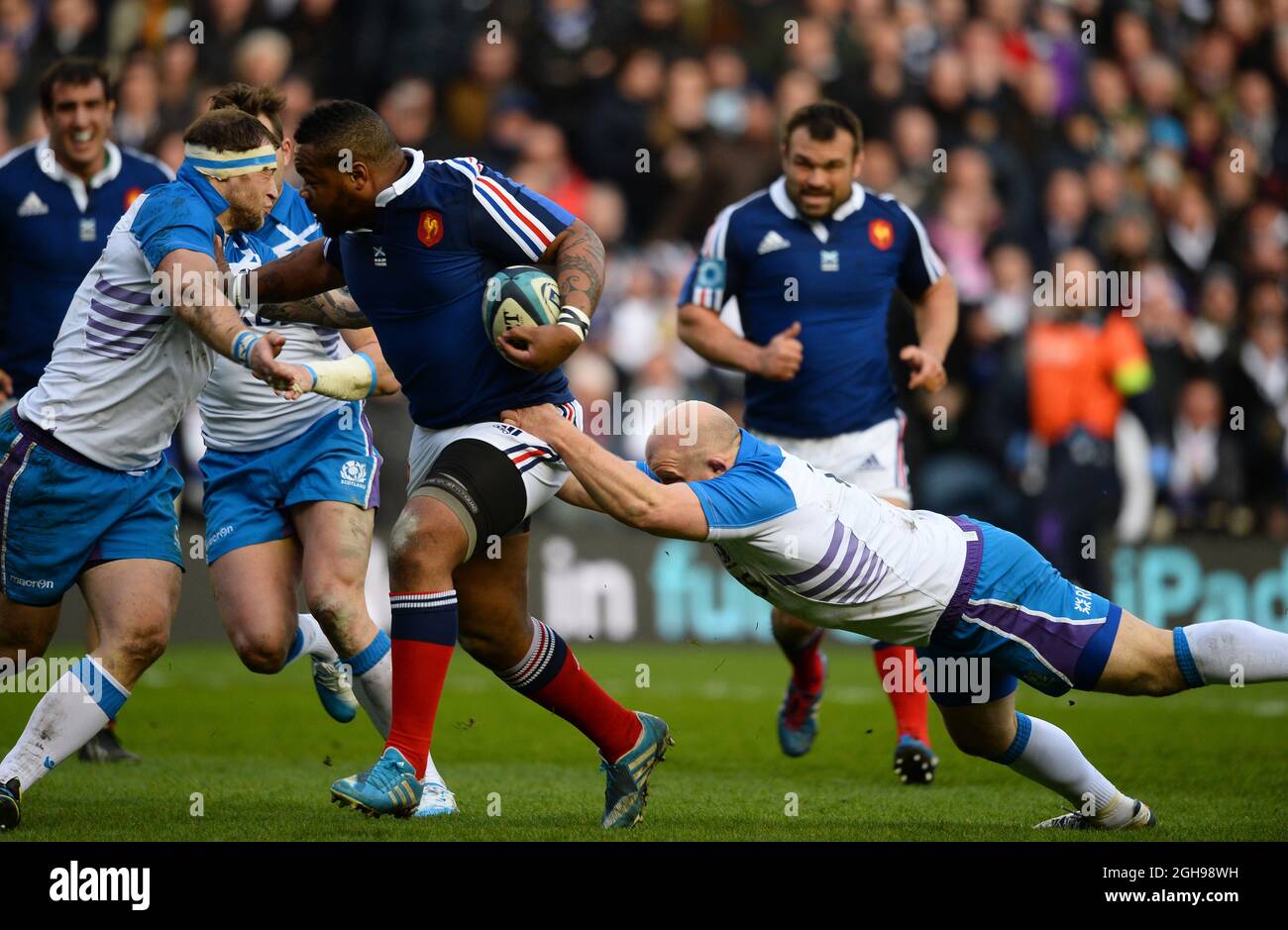 Mathieu Bastareaud of France burst through as Scott Lawson of Scotland ...