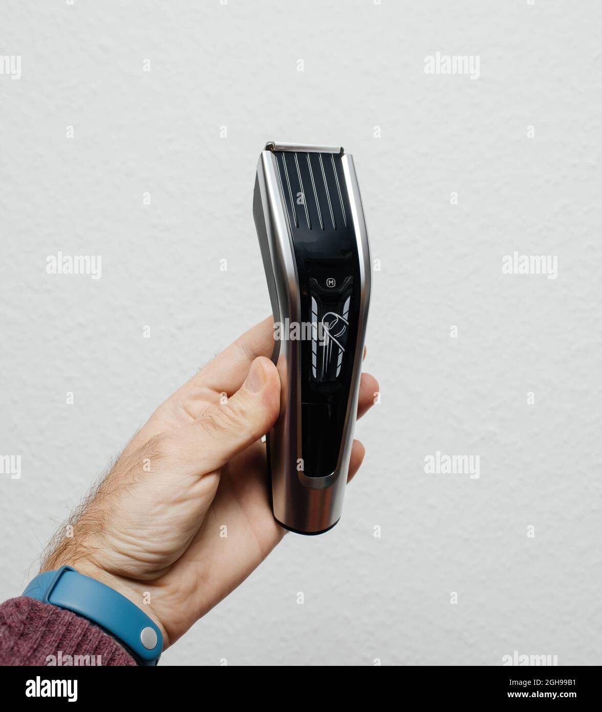 male hand holding new beard hair razor electric wire free device Stock ...