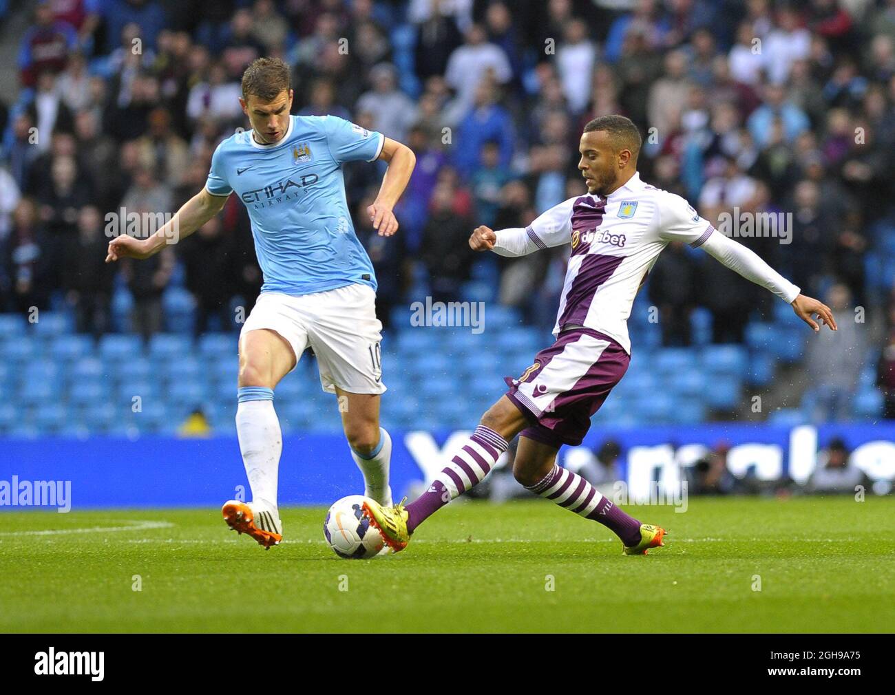 Ryan Bertrand of Aston Villa challenges Edin Dzeko of Manchester City during the Barclays ...