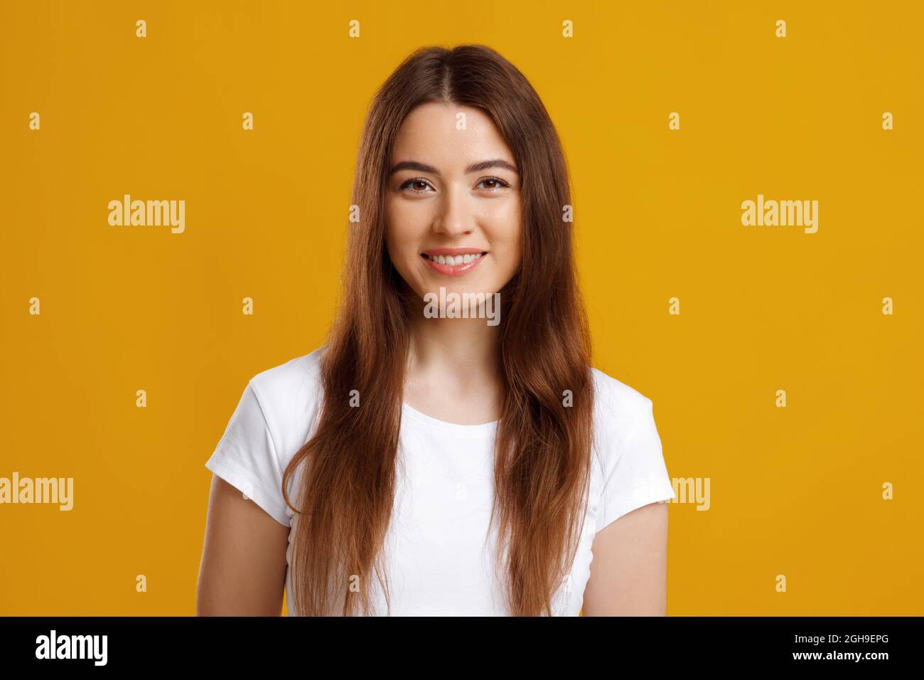 Attractive young woman posing on colorful studio background Stock Photo ...