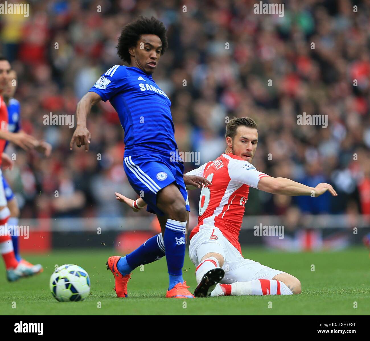 Arsenal's Aaron Ramsey tussles with Chelsea's Willian during the ...
