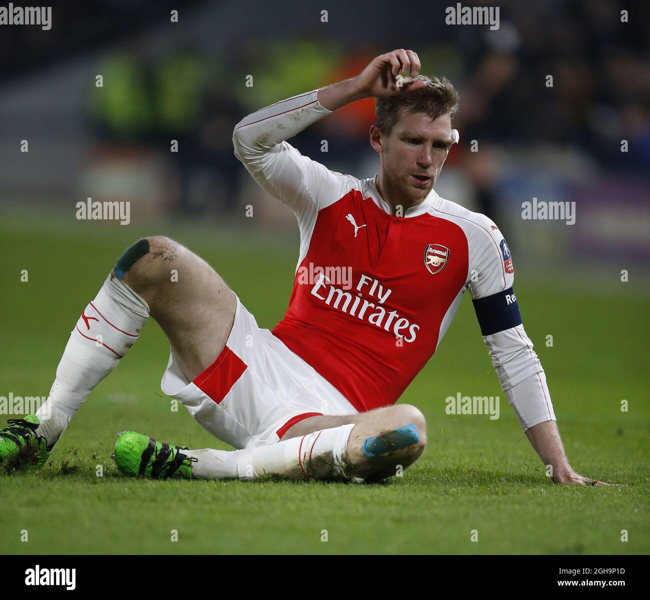 Per Mertesacker of Arsenal seems dazed moments before going off during ...