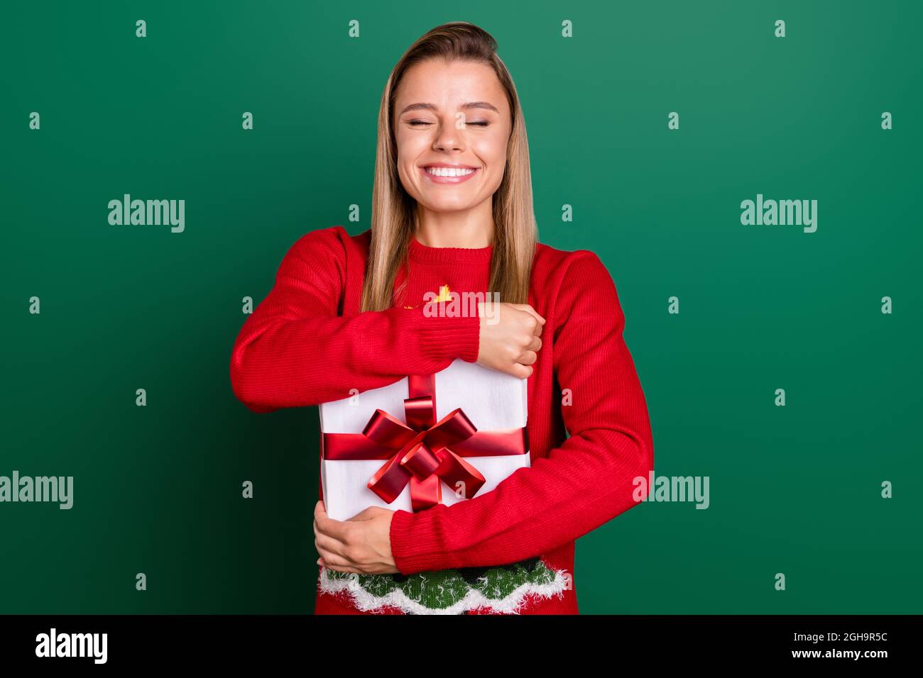 Portrait of attractive dreamy cheerful girl hugging giftbox December ...