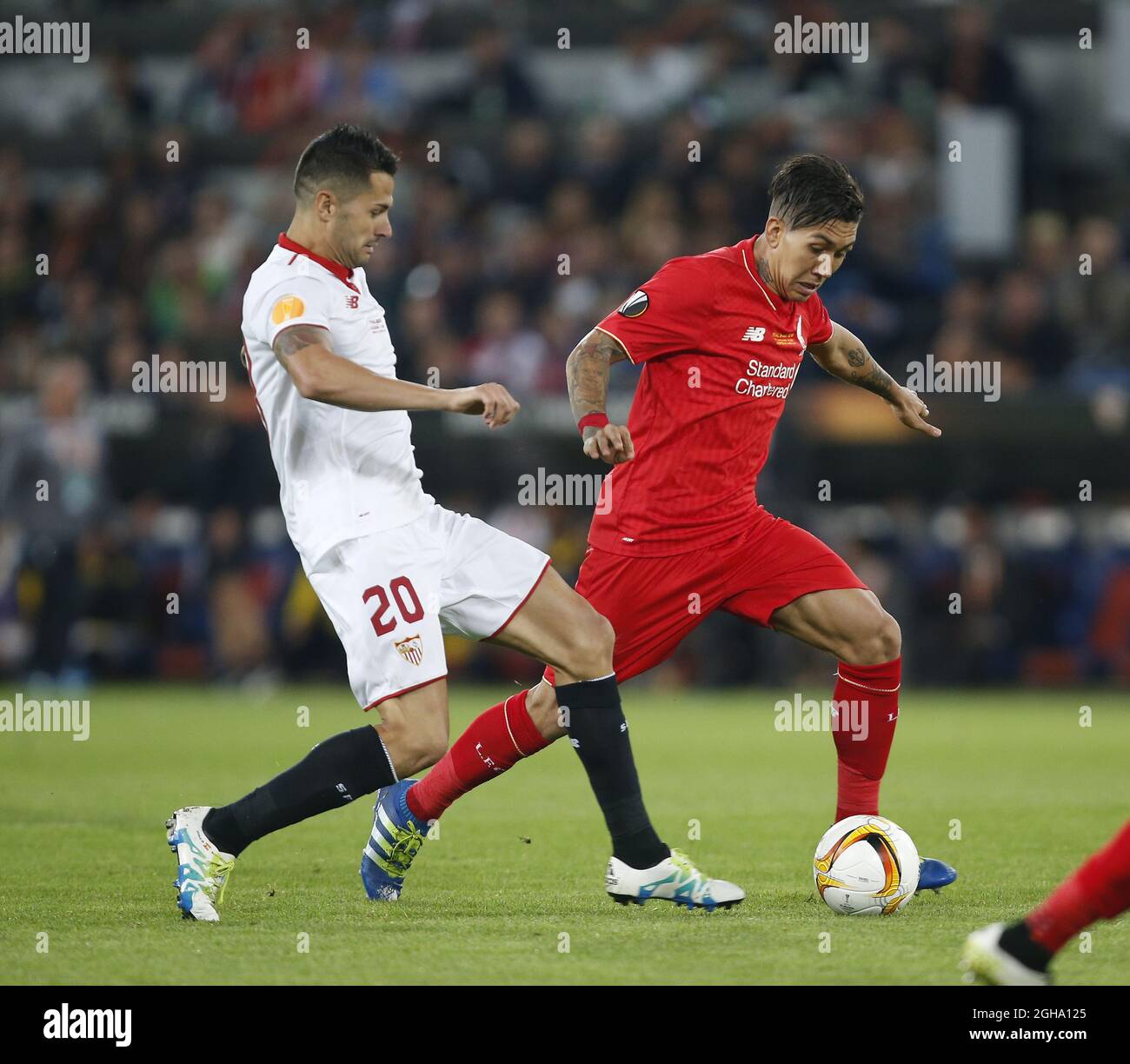 Vitolo of Sevilla tussles with Roberto Firmino of Liverpool during the ...