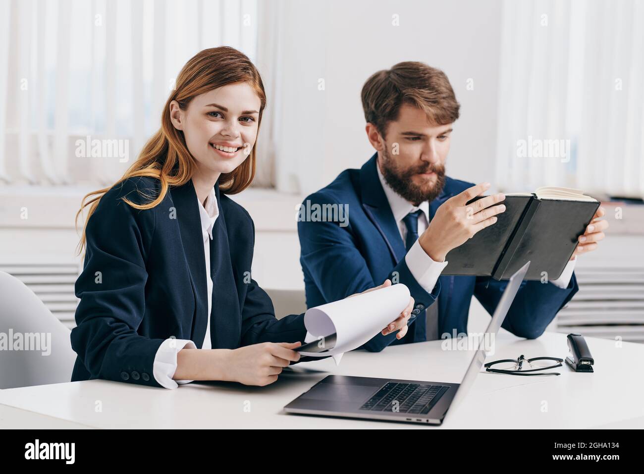 man and woman managers work together in front of laptop office ...