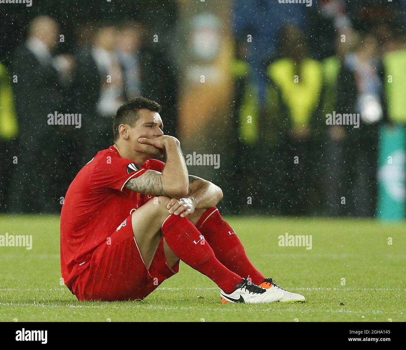 Dejan Lovren of Liverpool cries while sitting on the pitch during the ...