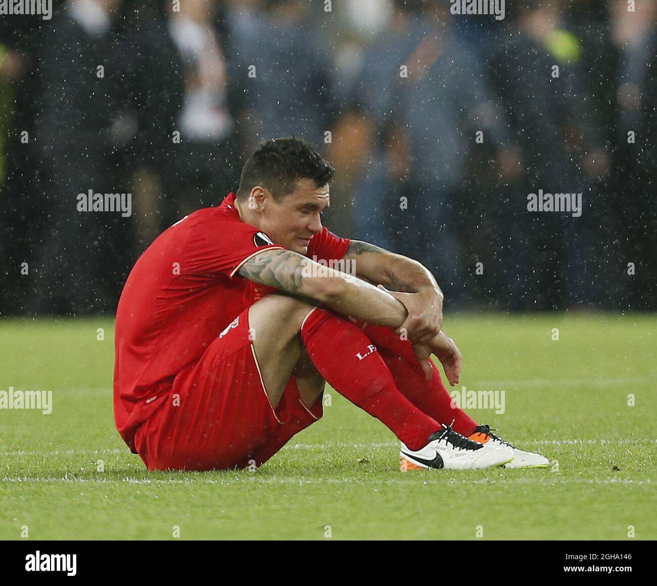 Dejan Lovren of Liverpool cries while sitting on the pitch during the ...