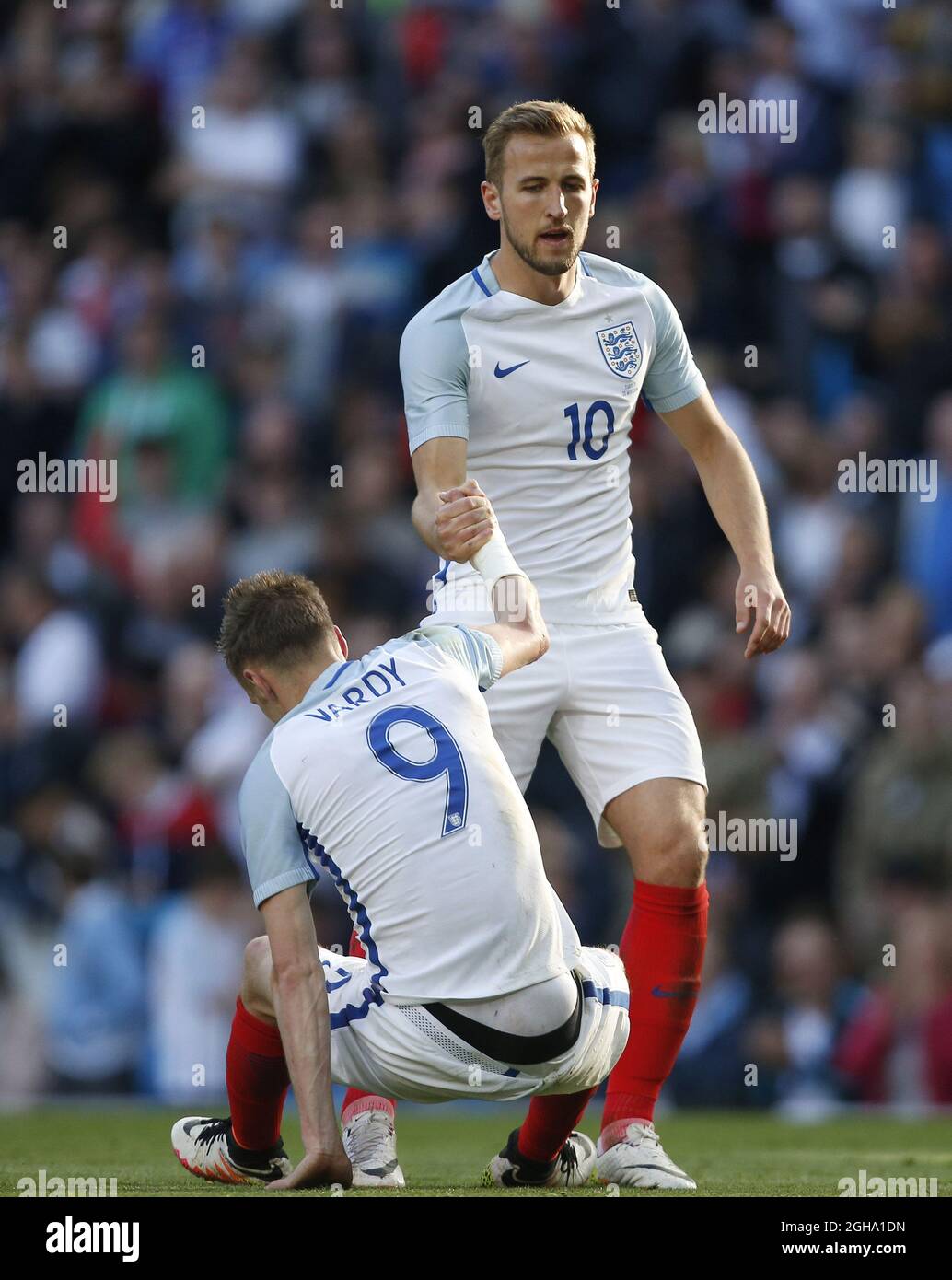 Harry Kane helps up Jamie Vardy of England during the international ...