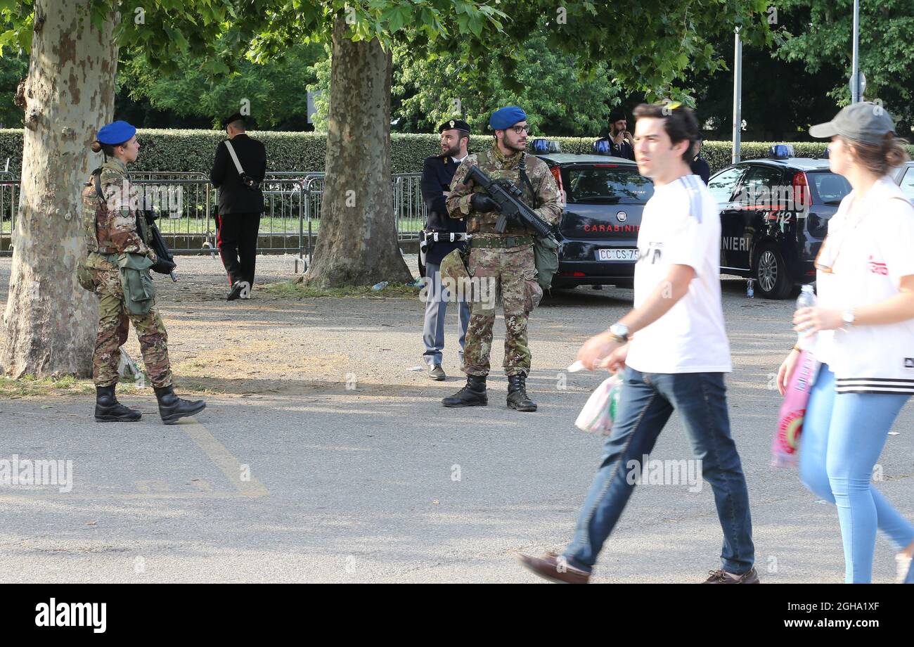 Armed police patrol the perimeter of the stadium as fans arrive during ...