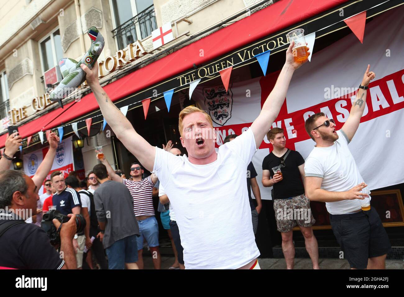 An England fan sings loudly with an inflatable spitfire ahead of their ...