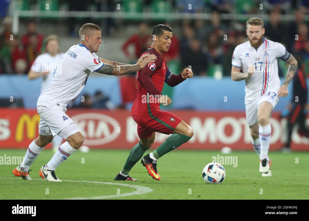 Ragnar Sigurdsson of Iceland holds off Cristiano Ronaldo of Portugal ...