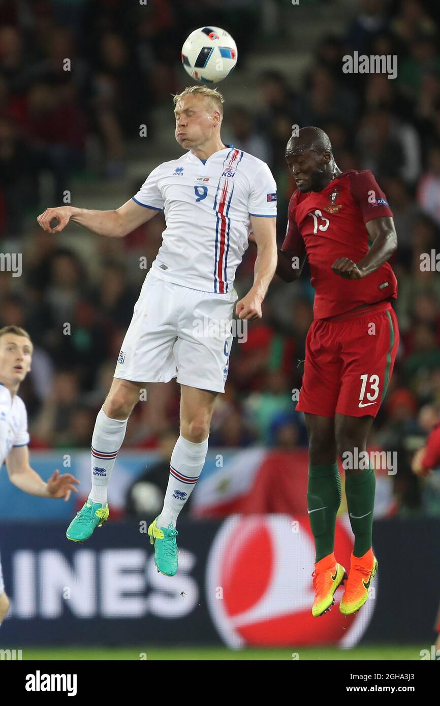 Kolbeinn Sigthorsson of Iceland tussles with Danilo of Portugal during ...