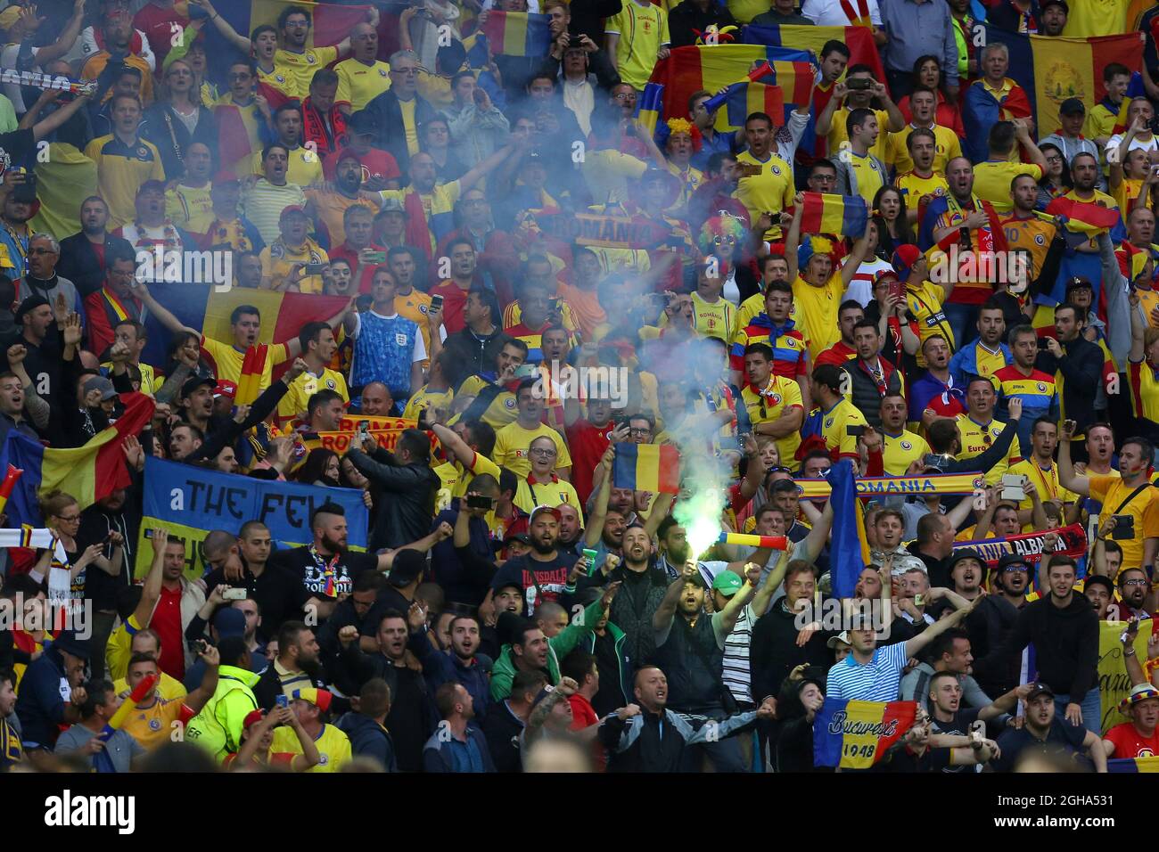 Romania fans light a flare during their anthem during the UEFA European ...