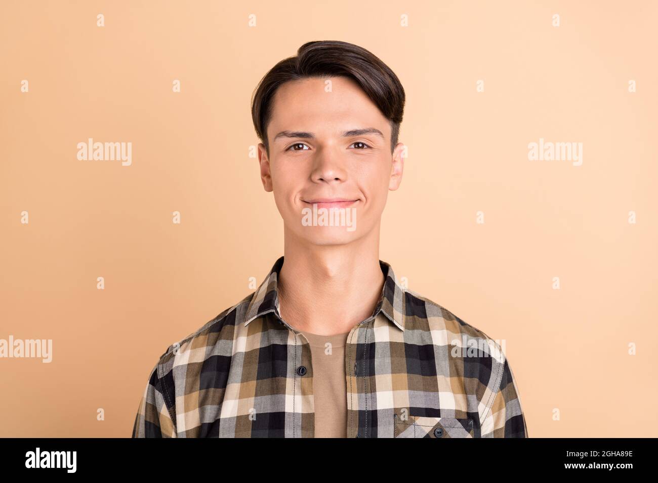 Photo of millennial cute guy wear checkered shirt isolated on beige ...