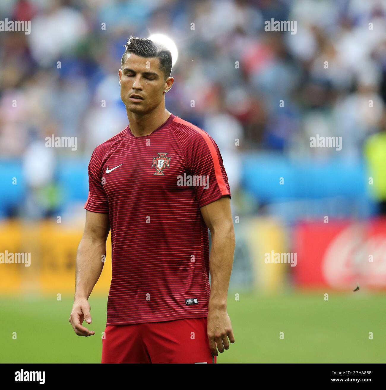 Cristiano Ronaldo of Portugal sighs as he wipes away moths during warm ...