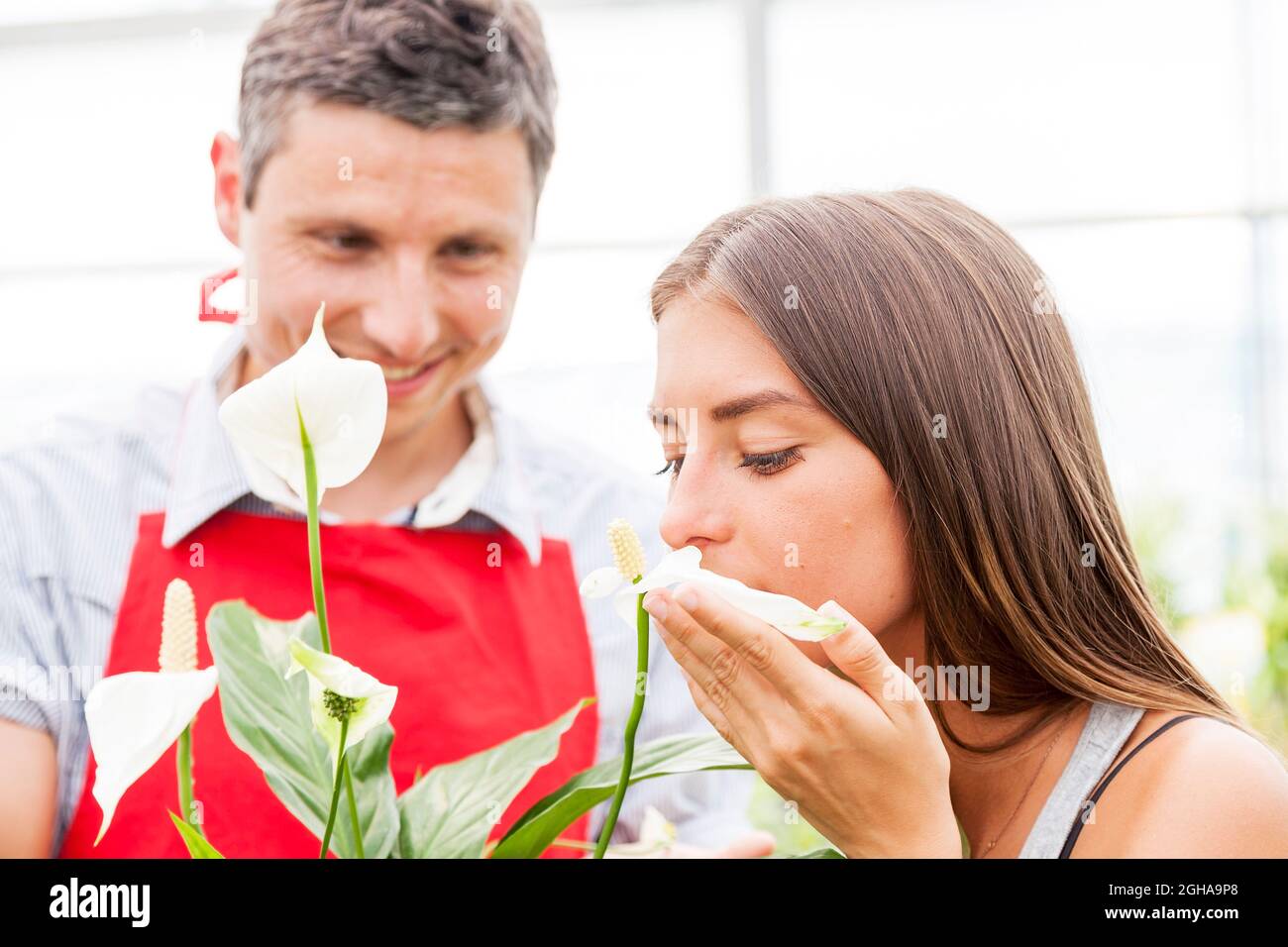 Young woman smelling white flower hi-res stock photography and images ...