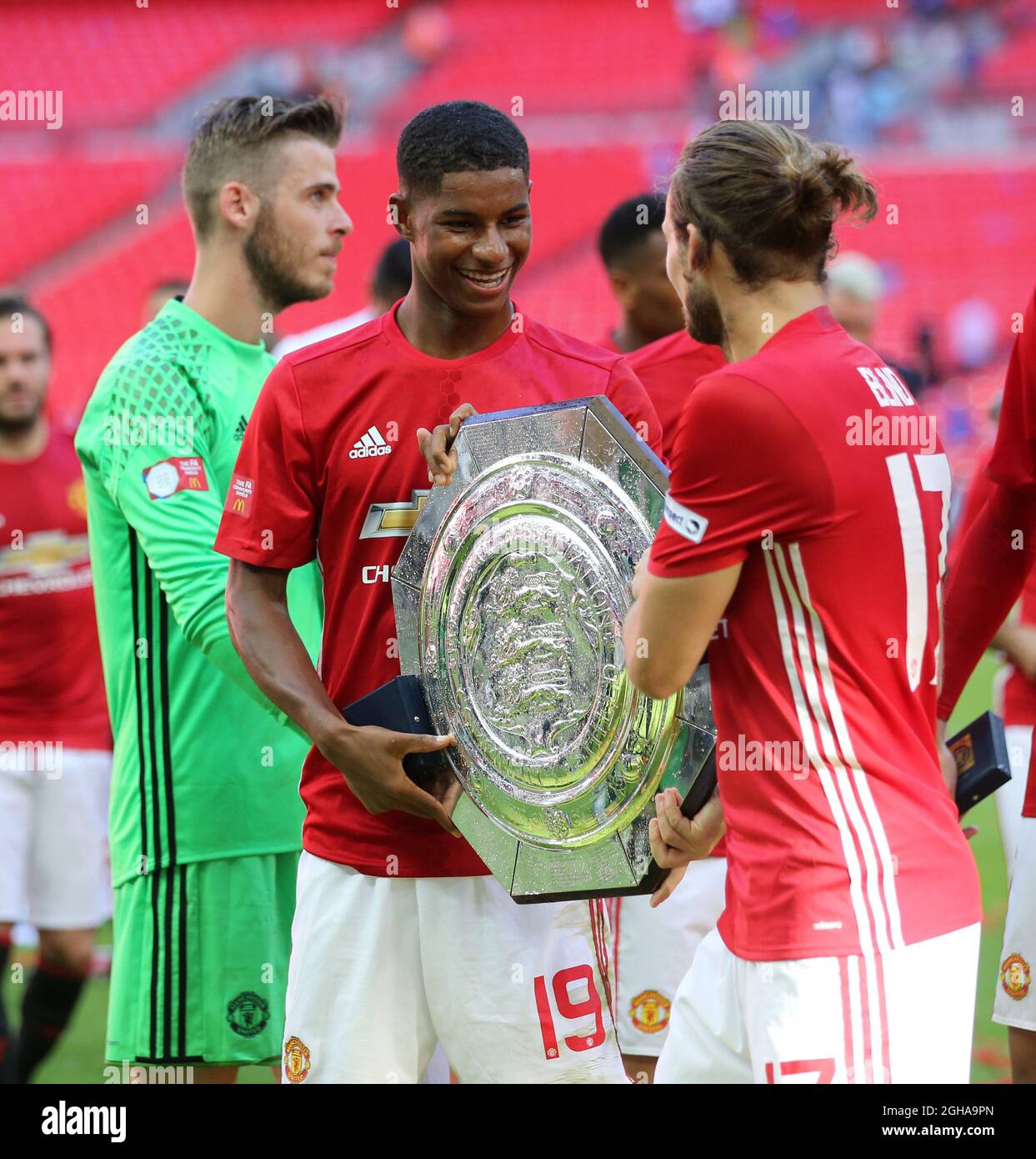 Manchester United's Marcus Rashford celebrates with the trophy during ...
