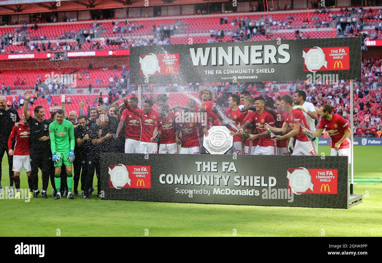 Manchester United's players and staff celebrate with the trophy during ...