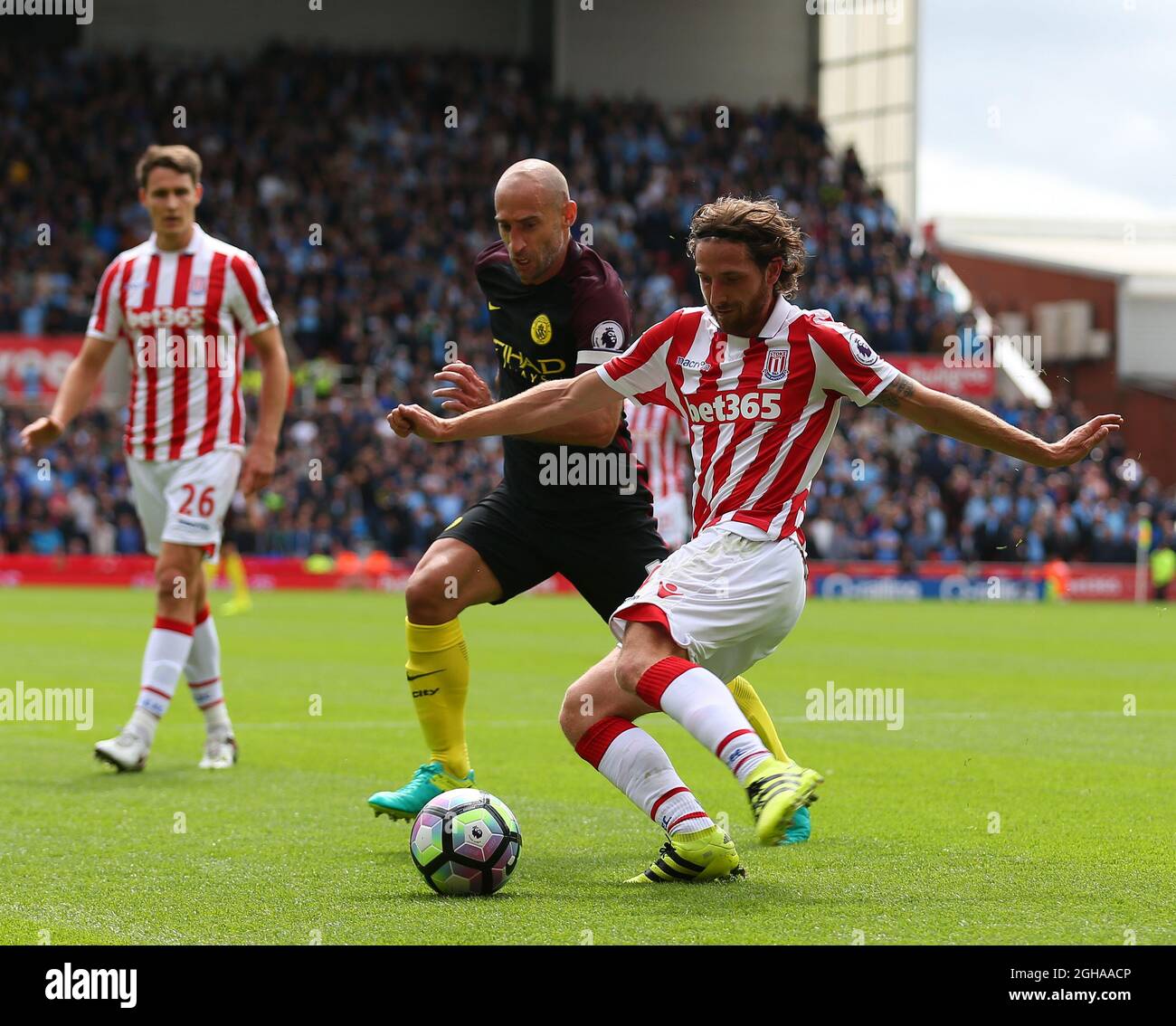 Joe Allen of Stoke City tussles with Pablo Zabaleta of Manchester City ...