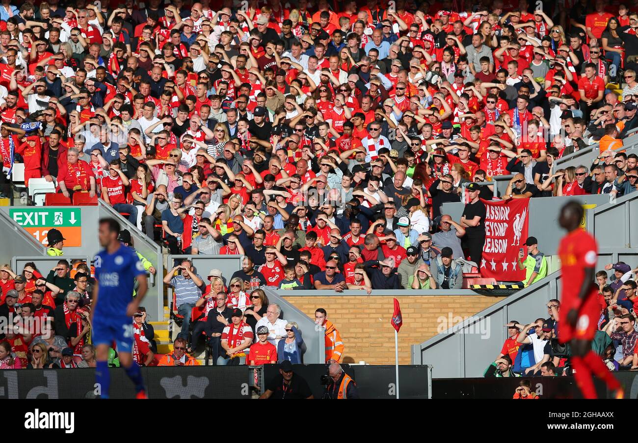 Liverpool fans watch in the sunshine during the Premier League match at ...