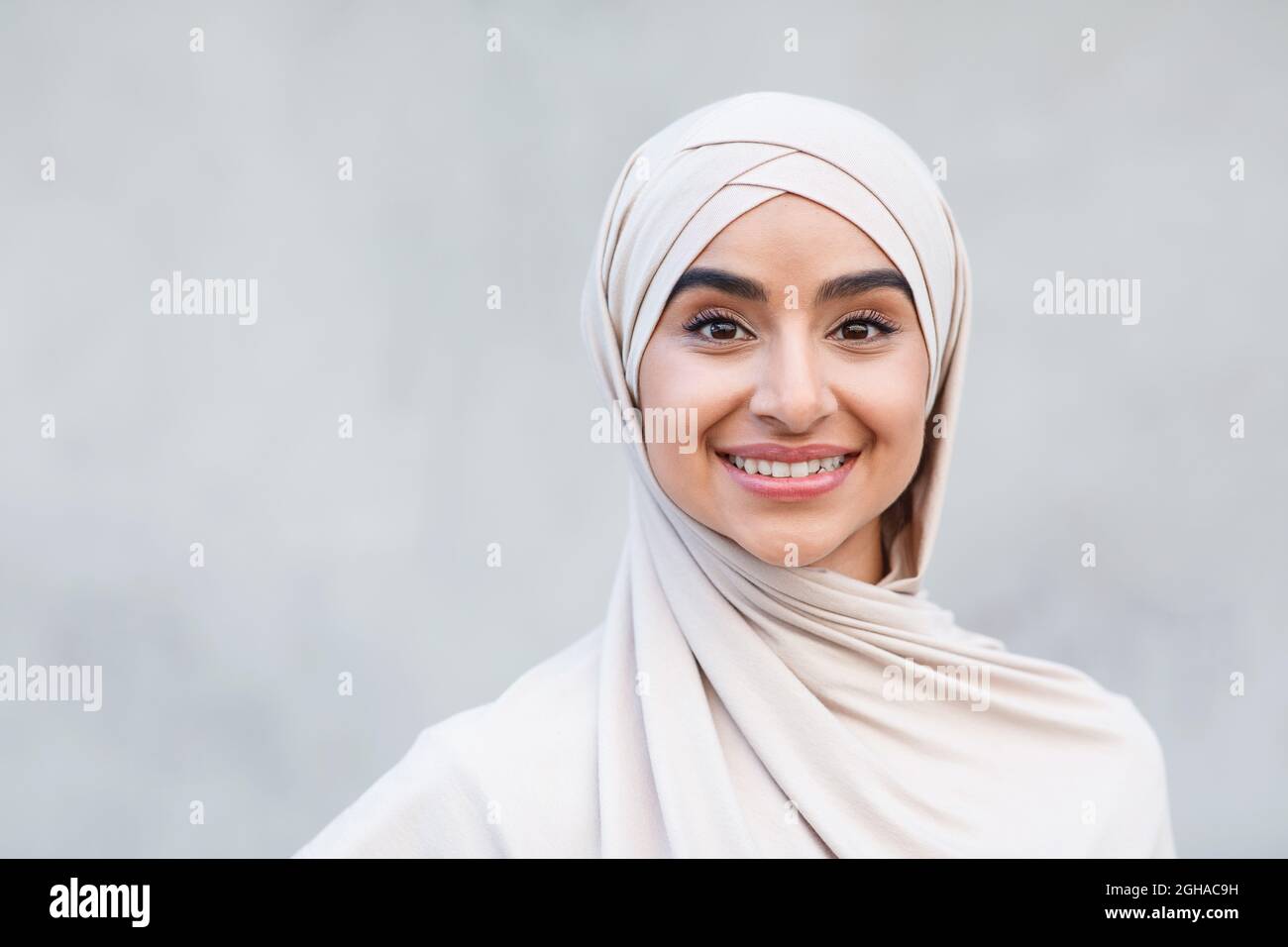 Portrait of cheerful cute attractive young arabian islamic female in ...