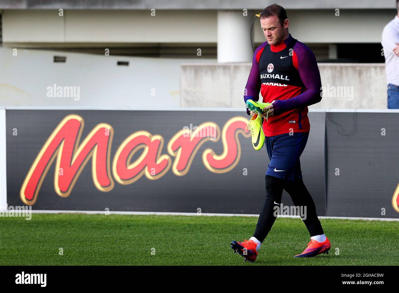 England captain Wayne Rooney carries spare boots during the training ...
