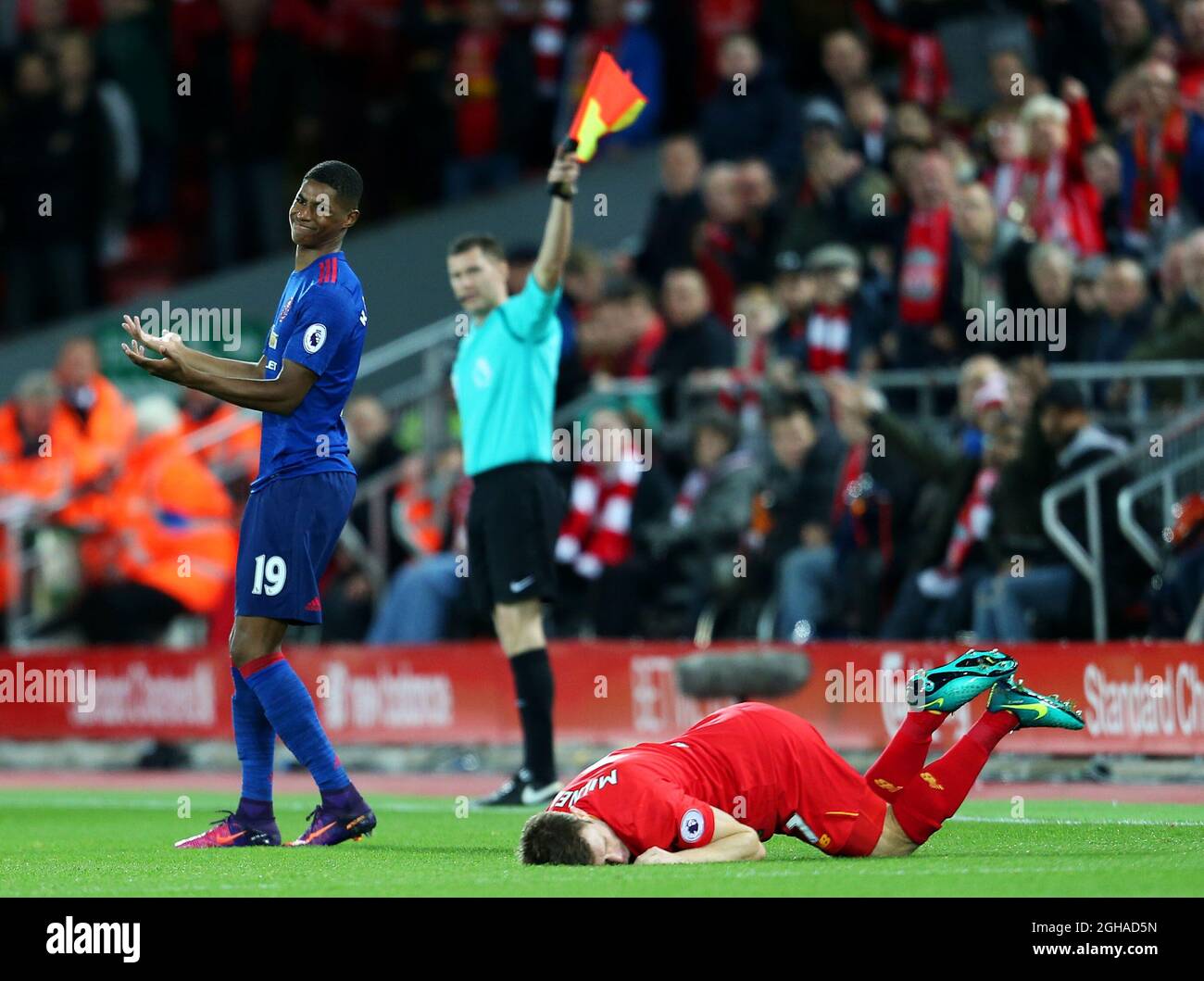 Wayne Rooney of Manchester United reacts after fouling James Milner of ...