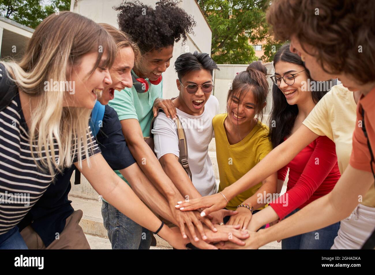 Group Of Teenage Friends High Fiving Each Other Happy And Motivated
