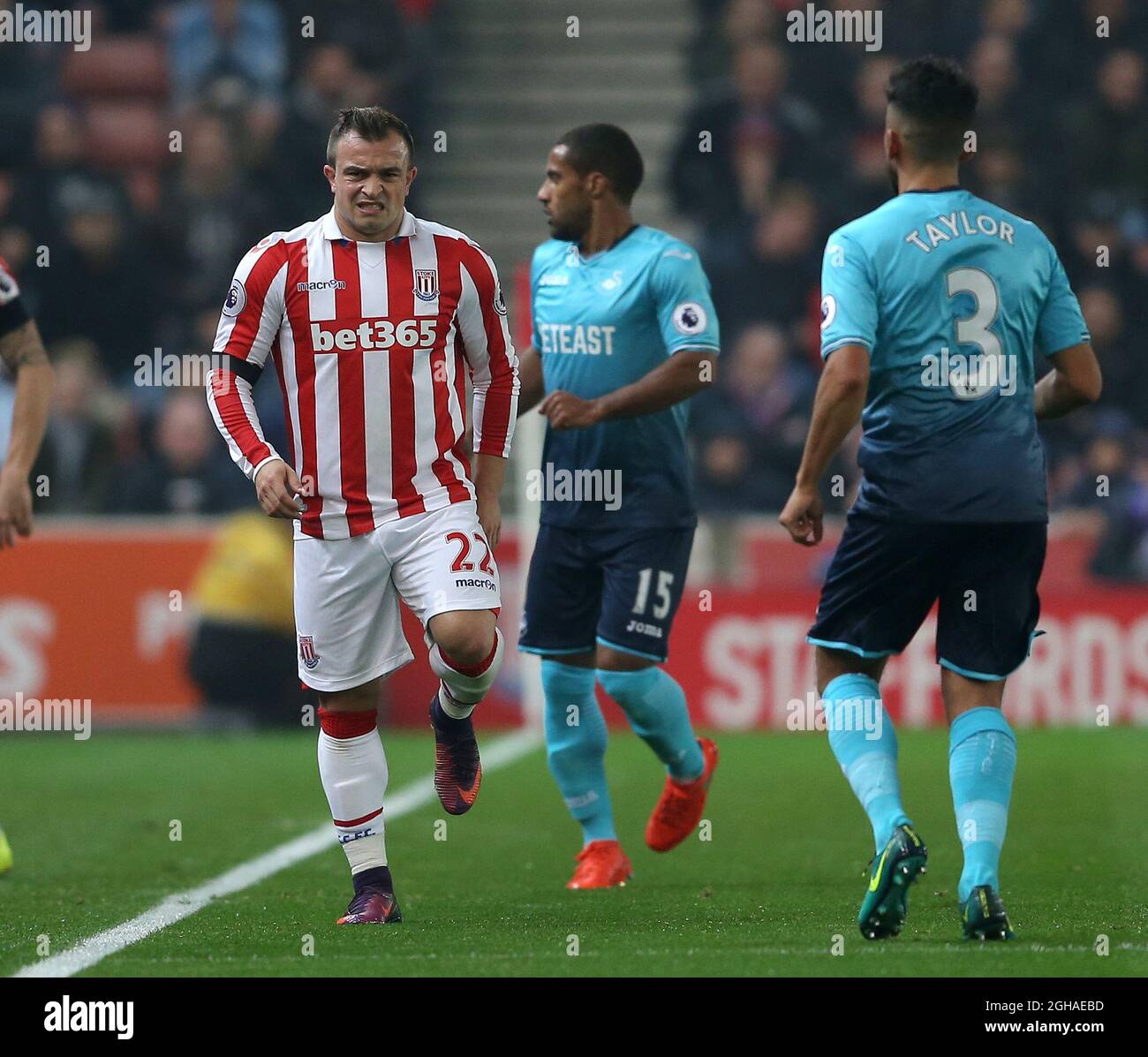 Xherdan Shaqiri of Stoke city holds his left leg before going off ...