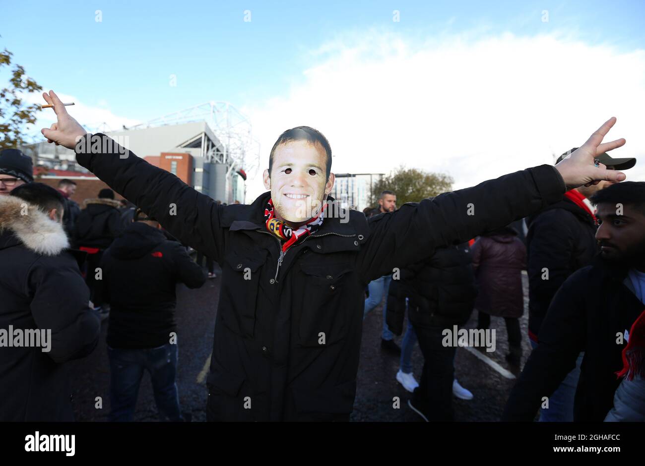 A Manchester United fan wears a Wayne Rooney mask during the Premier ...