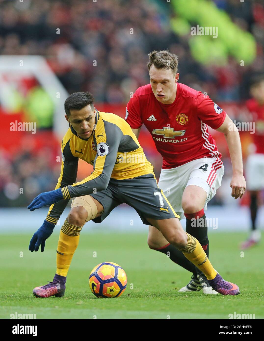 Manchester United's Phil jones tussles with Arsenal's Alexis Sanchez ...