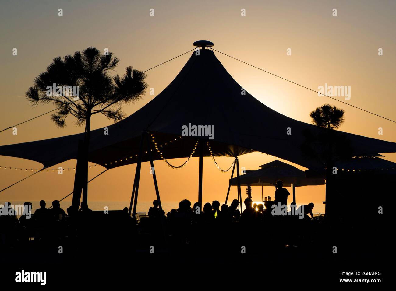 Beach bar at sunset Stock Photo - Alamy