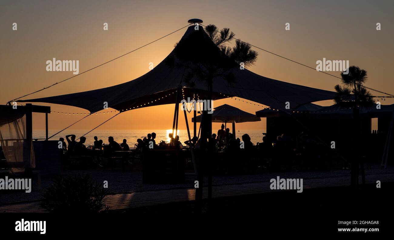 Beach bar at sunset Stock Photo - Alamy