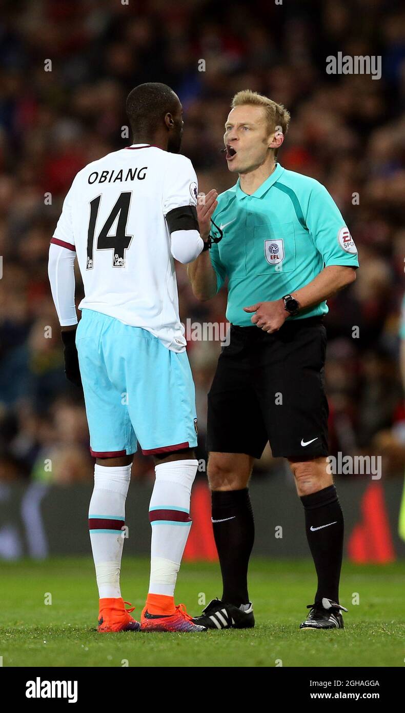 Referee Mike Jones talks to Pedro Mba Obiang of West Ham United during ...