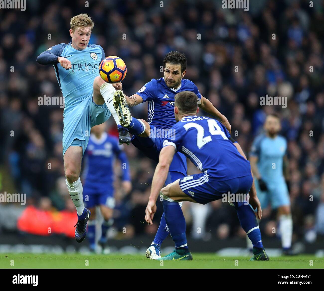 Kevin De Bruyne of Manchester City tackles Cesc Fabregas of Chelsea ...