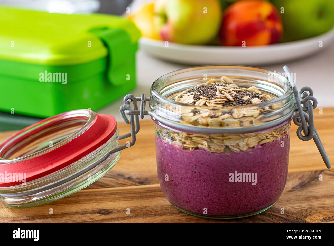 Breakfast to go. Blureberry yogurt with oats and chia seeds in a glass ...