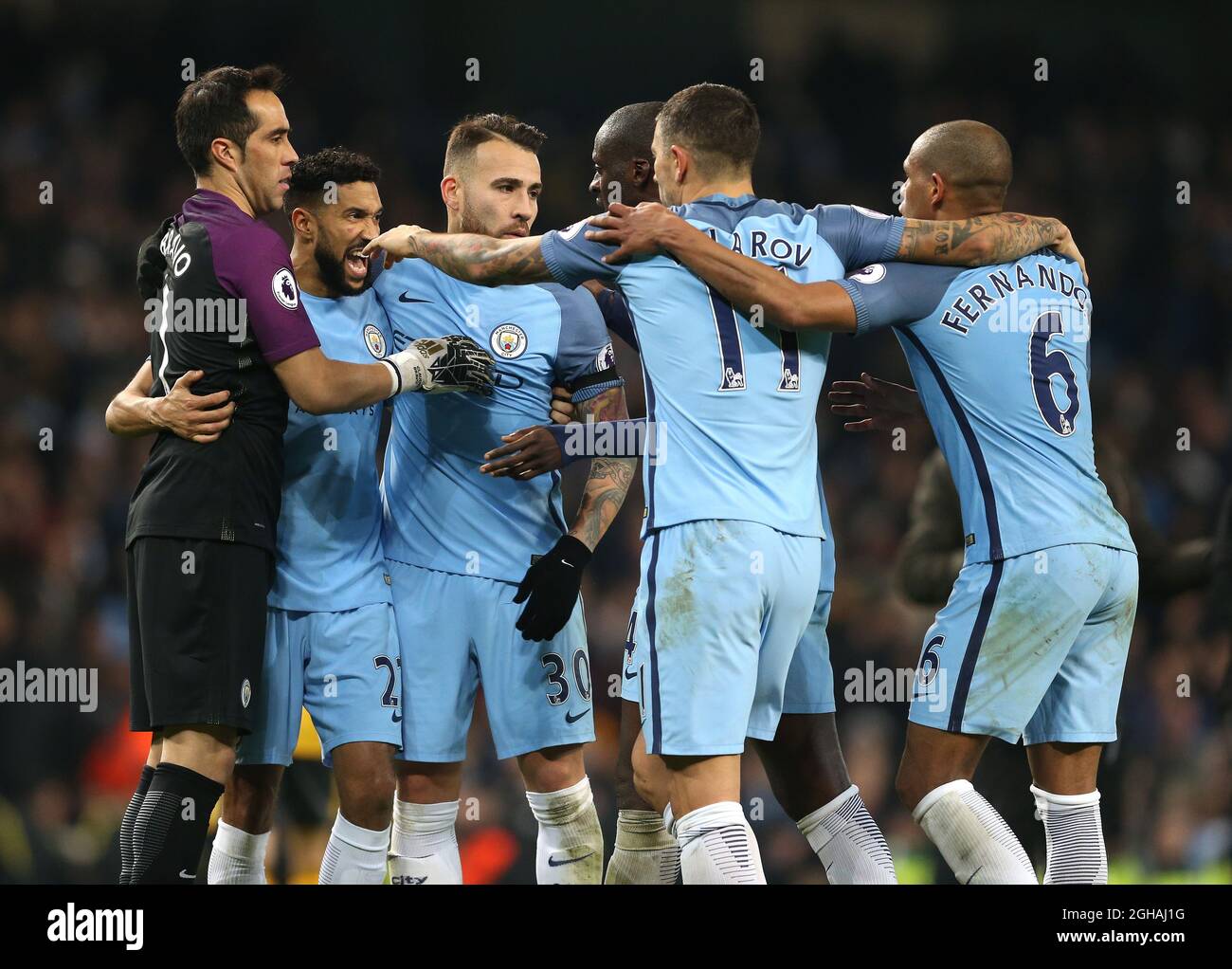 Manchester City players come together to celebrate during the English ...